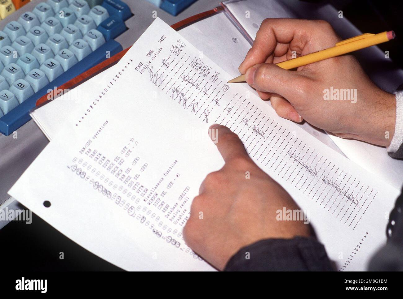 A member of the 6949th Electronic Security Squadron fills out paperwork ...