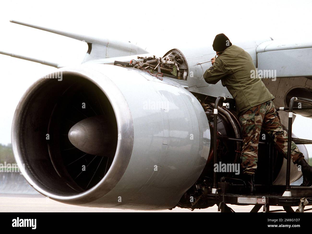 A ground crew member works on an engine of a 55th Strategic ...