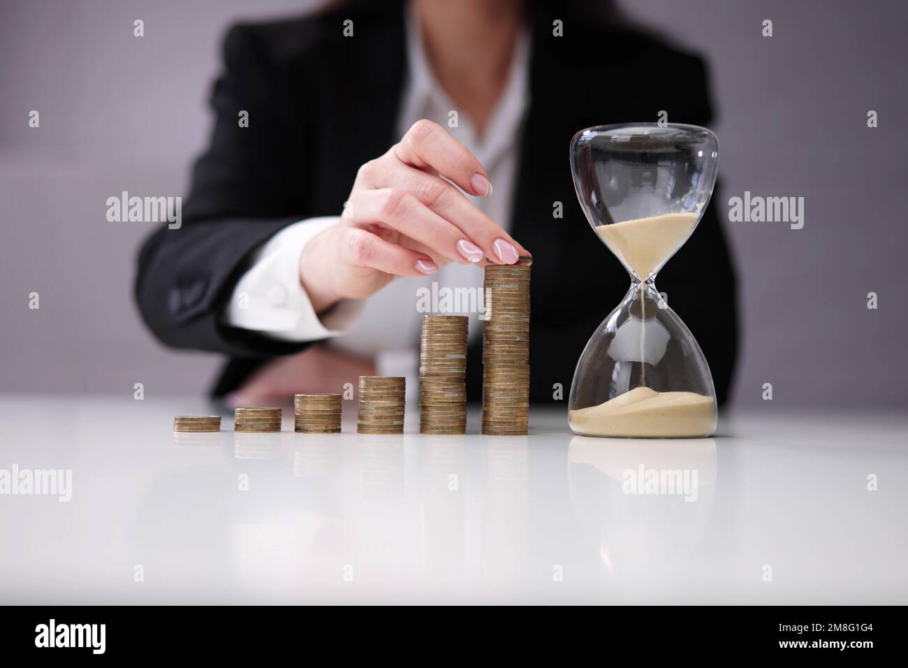 Increasing Money Coin Stack Concept. Hourglass And Time Stock Photo - Alamy