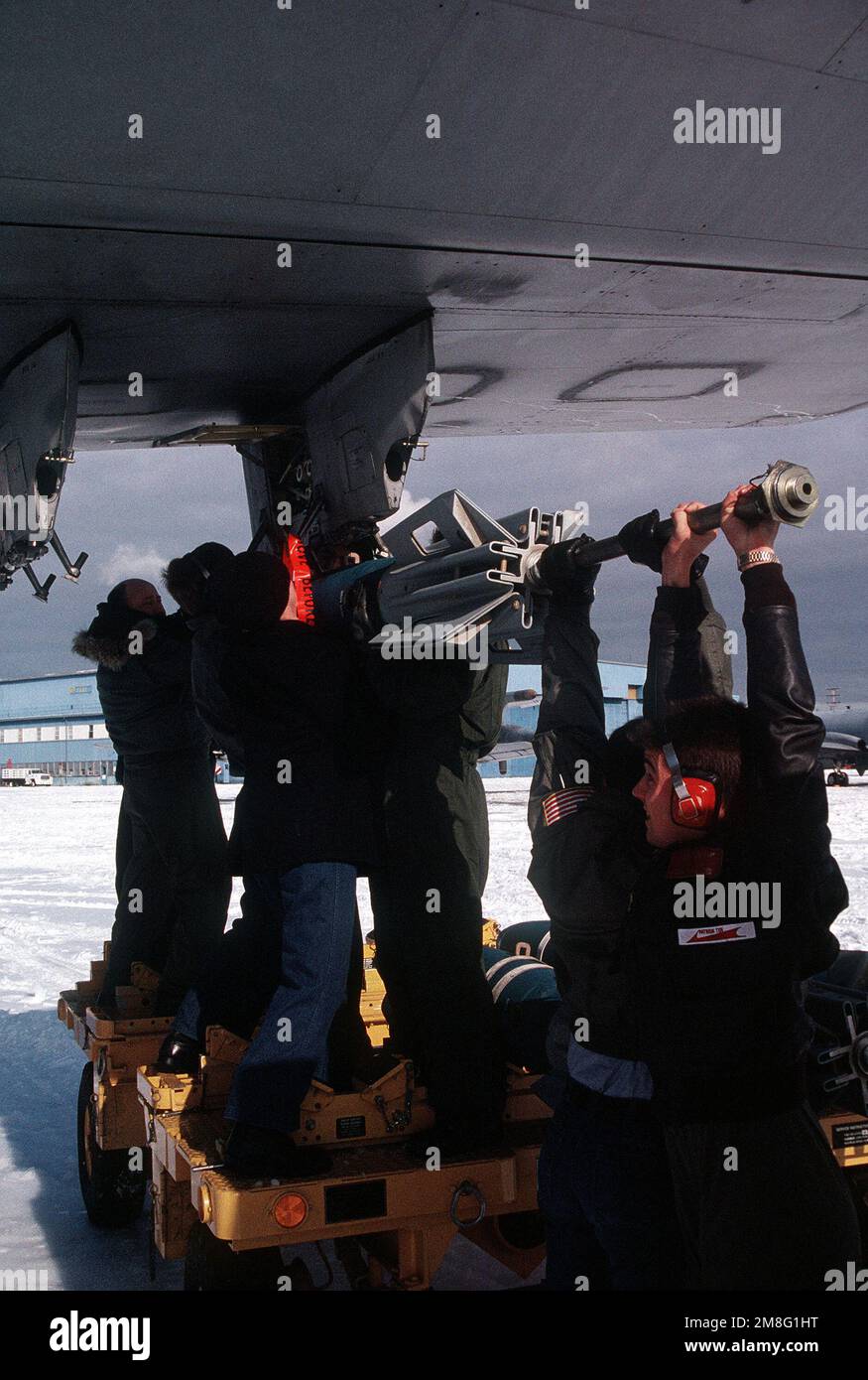 Aviation ordnancemen of Patrol Squadron 10 (VP-10) lift a Mark 82 500 ...