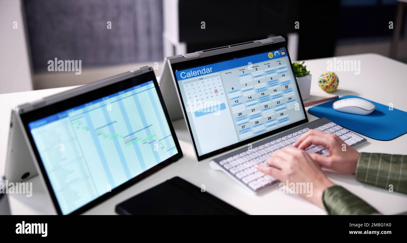 Employee Looking Calendar Schedule On Computer Screen Stock Photo - Alamy