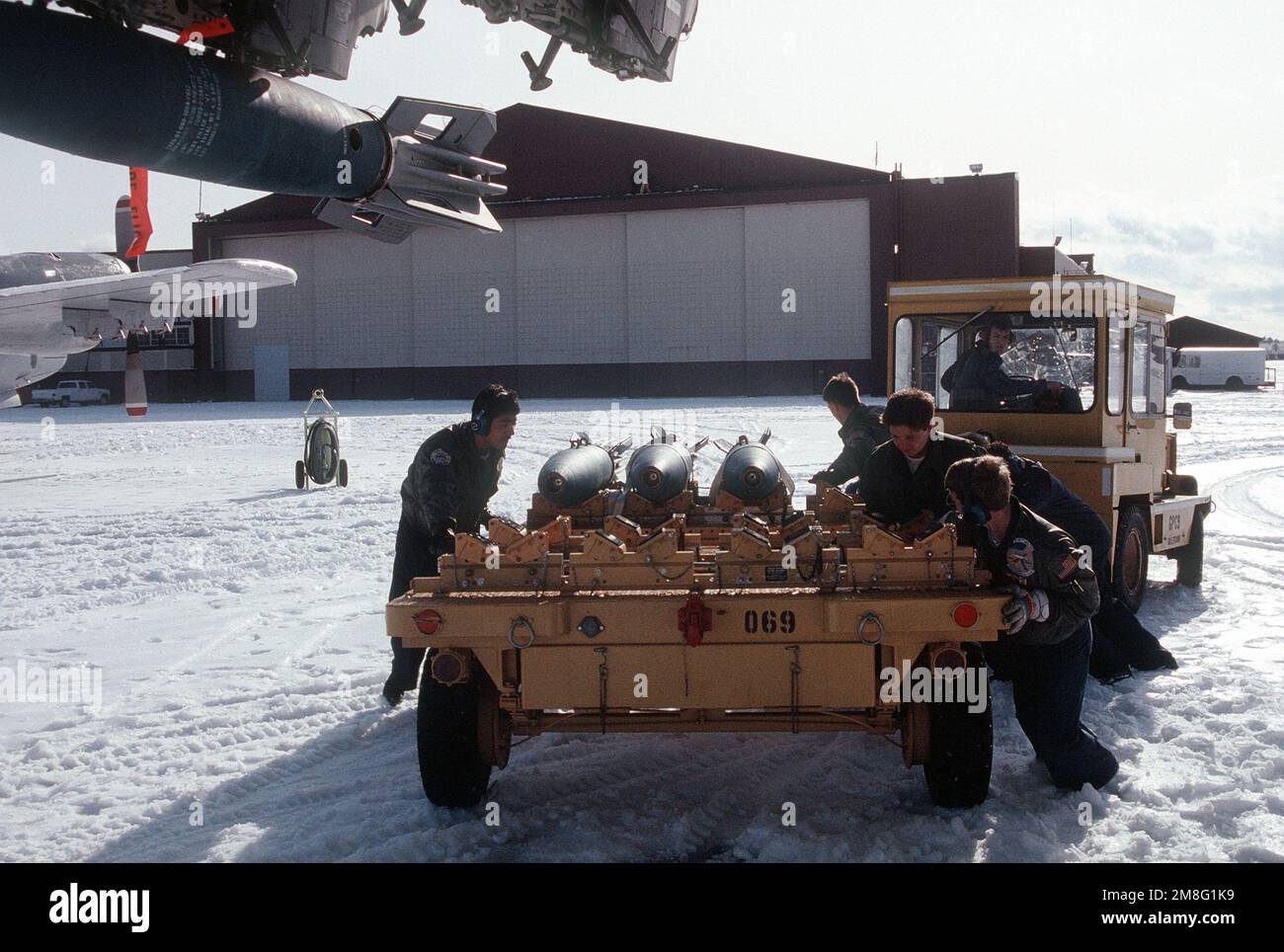 Aviation ordnancemen of Patrol Squadron 10 (VP-10) position a munitions ...