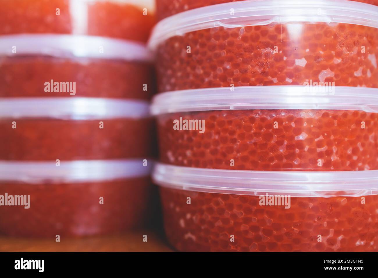 Red caviar plactic jars, rows of salted canned red caviar containers ...