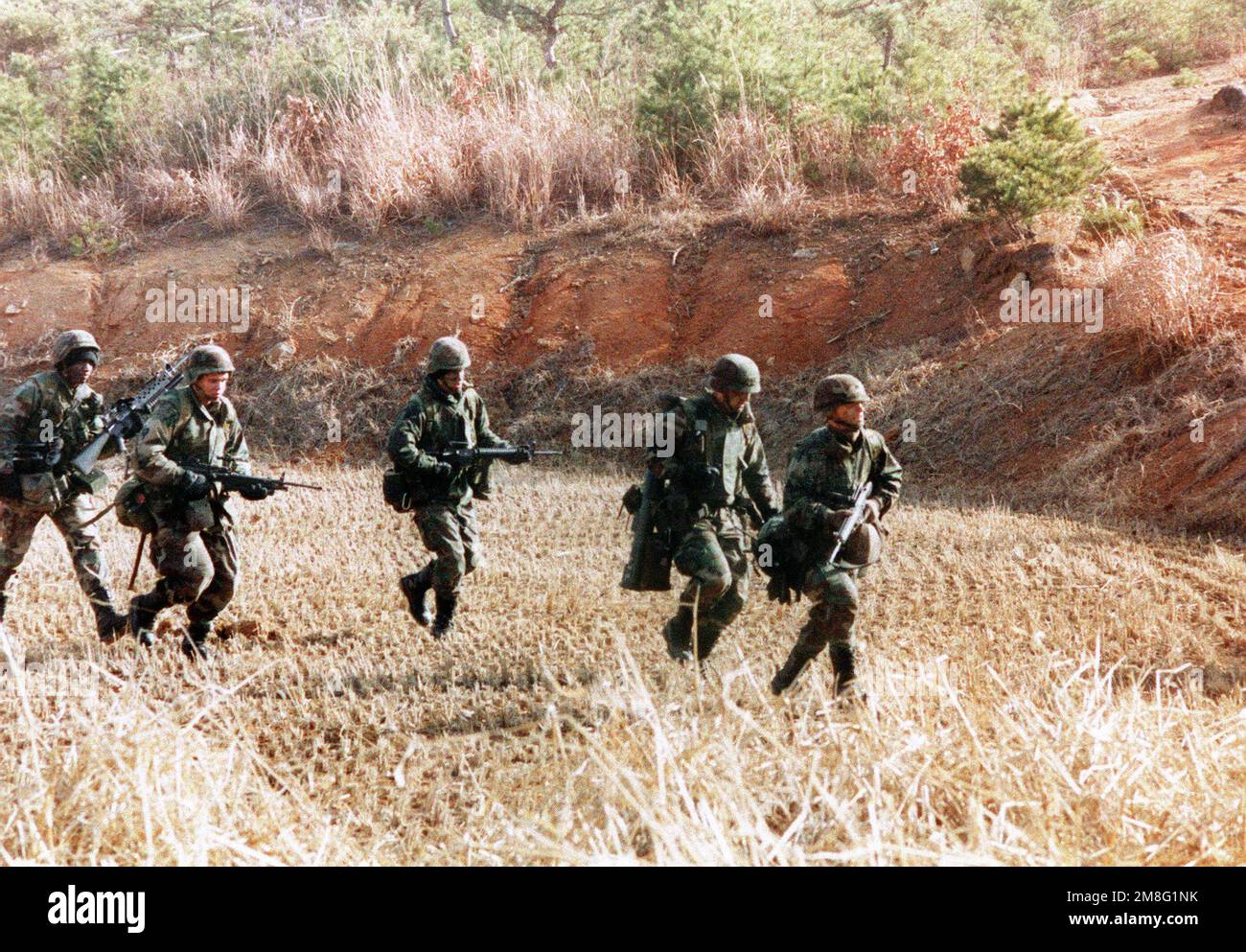 Members of the 1ST, 506th Infantry Battalion on patrol during a Live Fire training exercise at ...