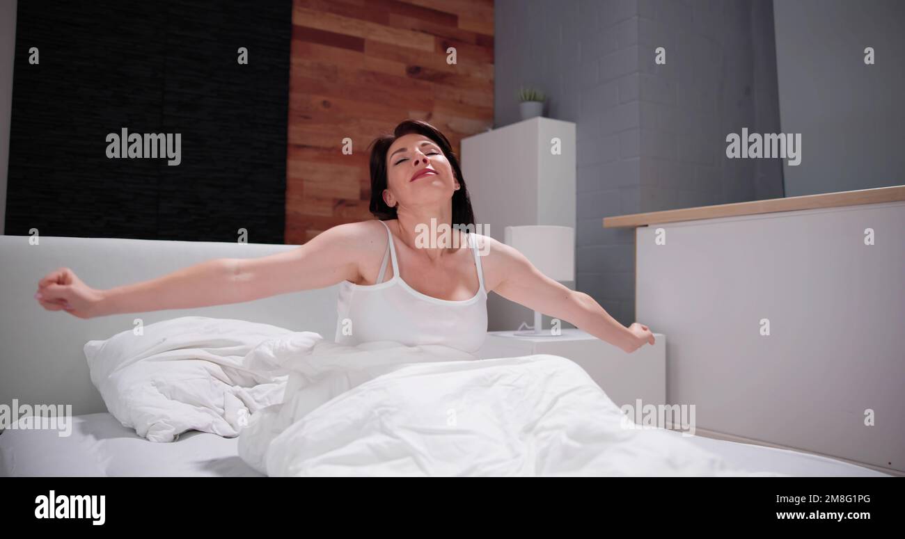 Woman Waking Up. Whole Body Wakeup And Stretching Stock Photo - Alamy