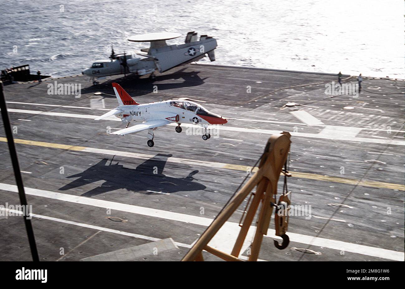 A T-45A Goshawk trainer aircraft prepares to catch the arresting cable ...