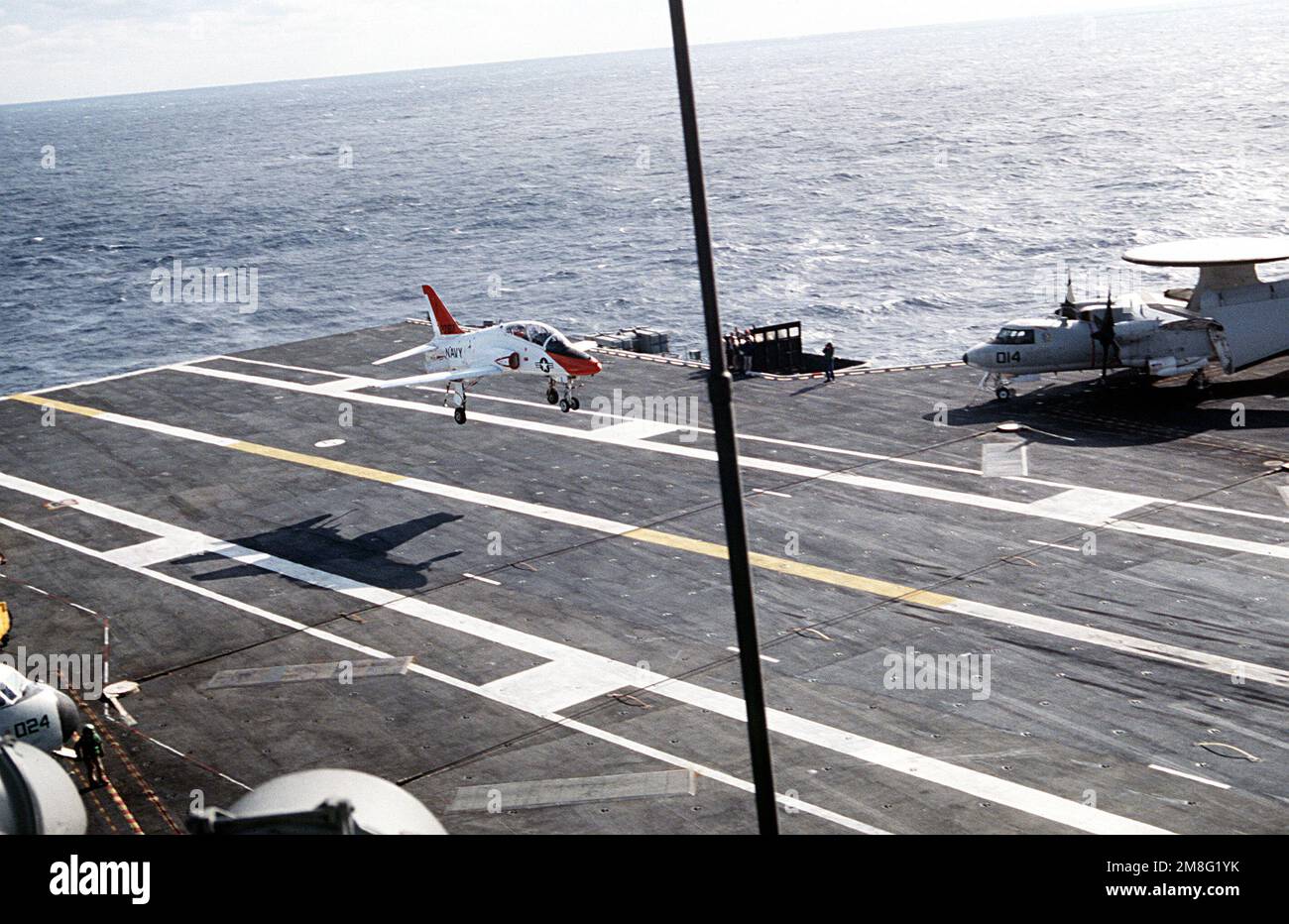 A T-45A Goshawk trainer aircraft prepares to catch the arresting cable ...
