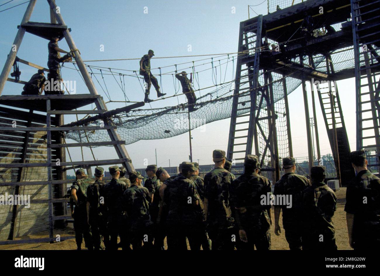 Soldiers climb over a rope bridge during basic training session on the ...