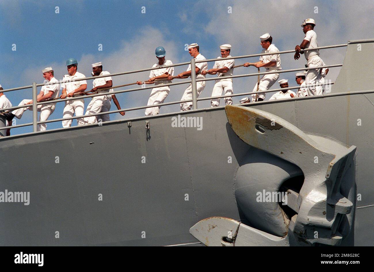 The deck crew of the USS MISSOURI (BB-63) handles the mooring lines as ...