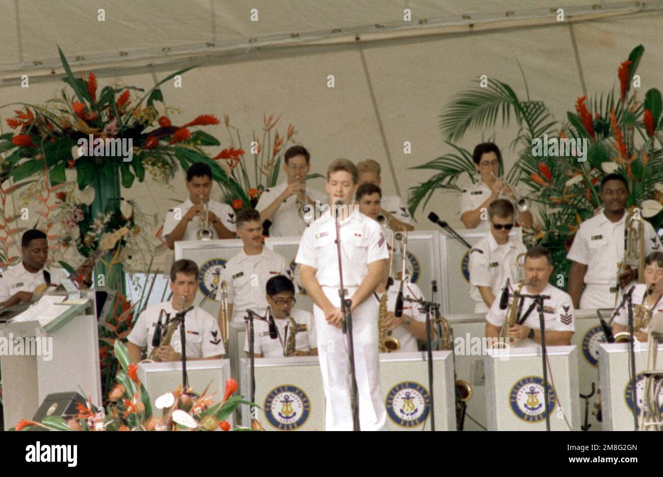 A soloist sings with the Pacific Fleet Band during one of the ...