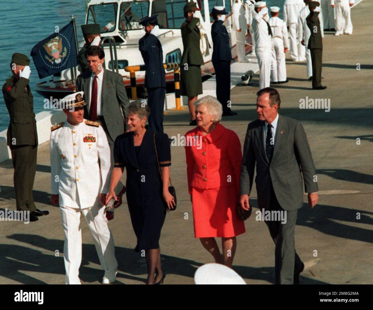 President George Bush, right, and his wife, Barbara, are accompanied by ...