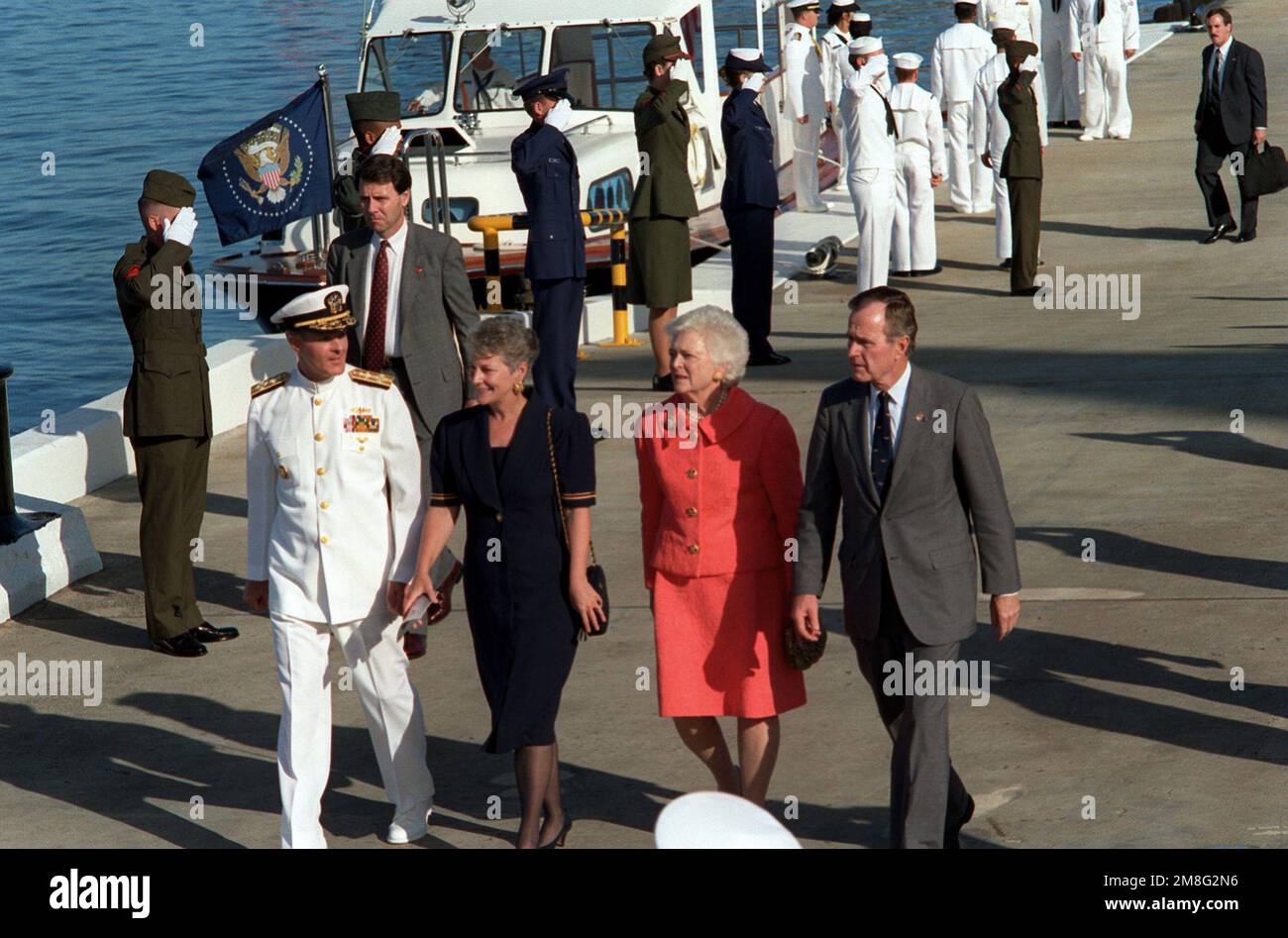 President George Bush and Mrs. Bush are escorted by ADM Charles R ...