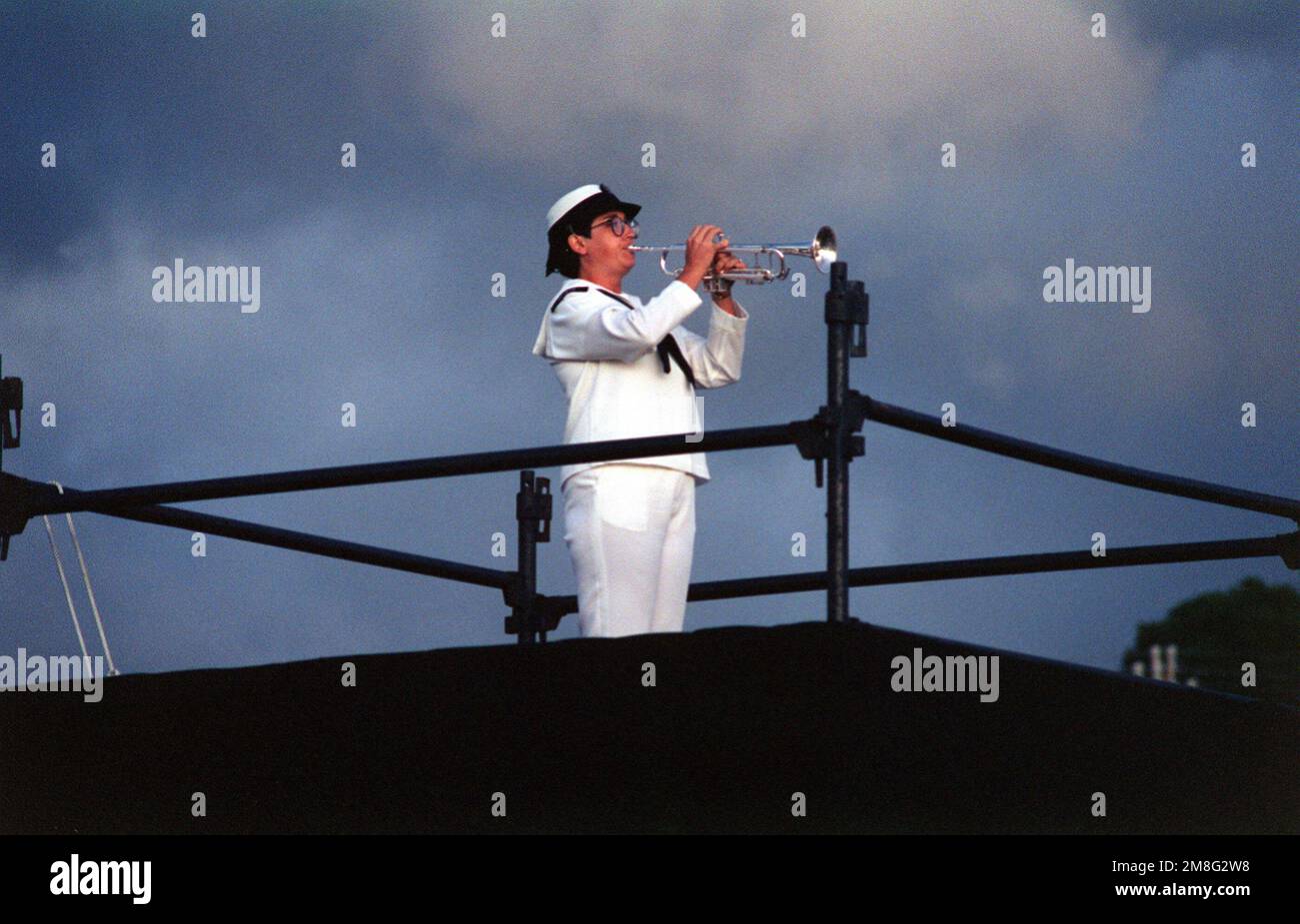 A trumpeter plays Taps at the conclusion of the Sunset Ceremony for ...