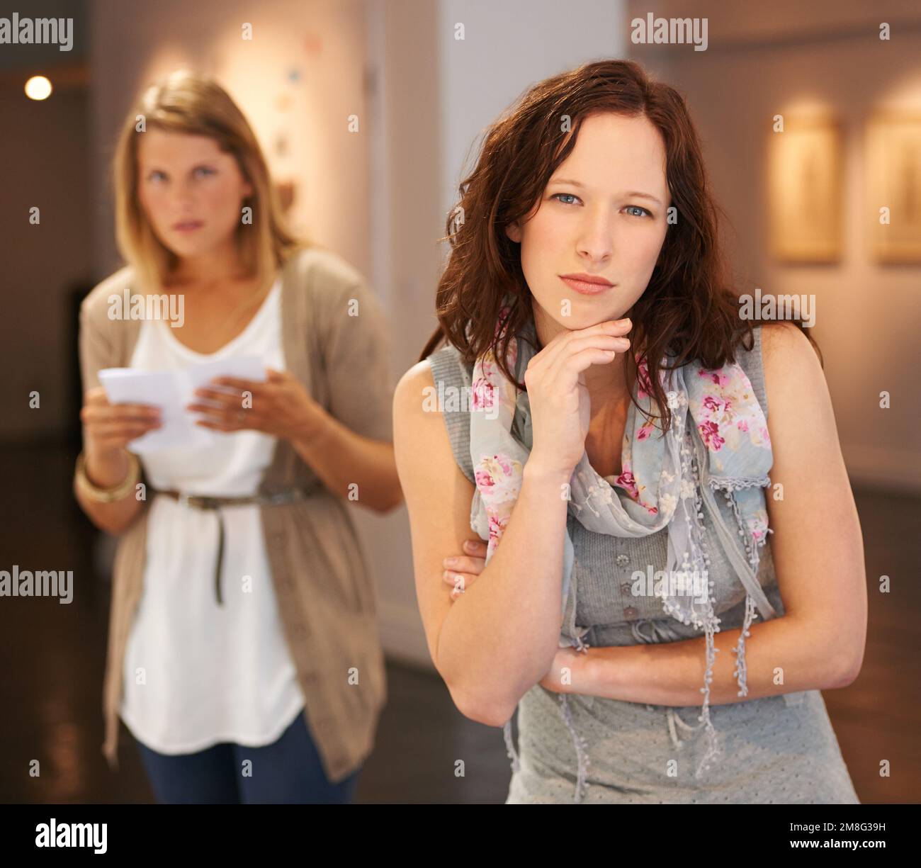 Art means different things to different people. two young women looking ...