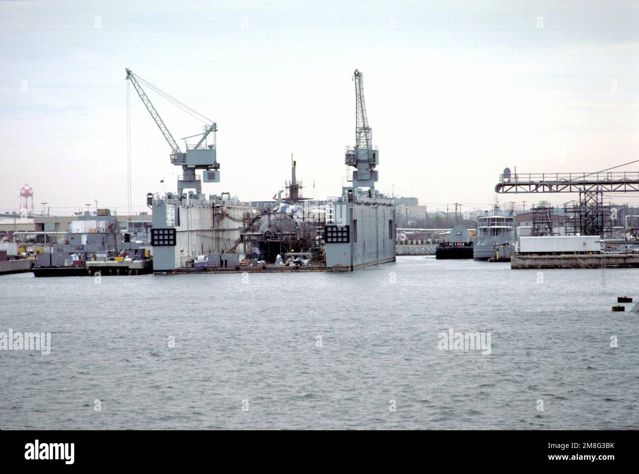A nuclear-powered attack submarine lies in a medium auxiliary floating ...