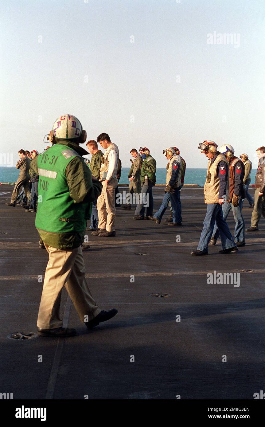 Crew members conduct a foreign object damage (FOD) walkdown on the ...