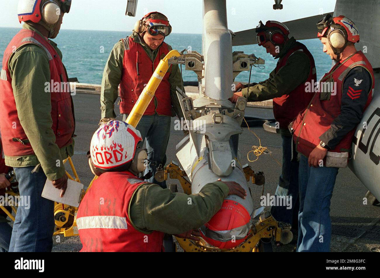 Ordnance crew members aboard the nuclear-powered aircraft carrier USS ...