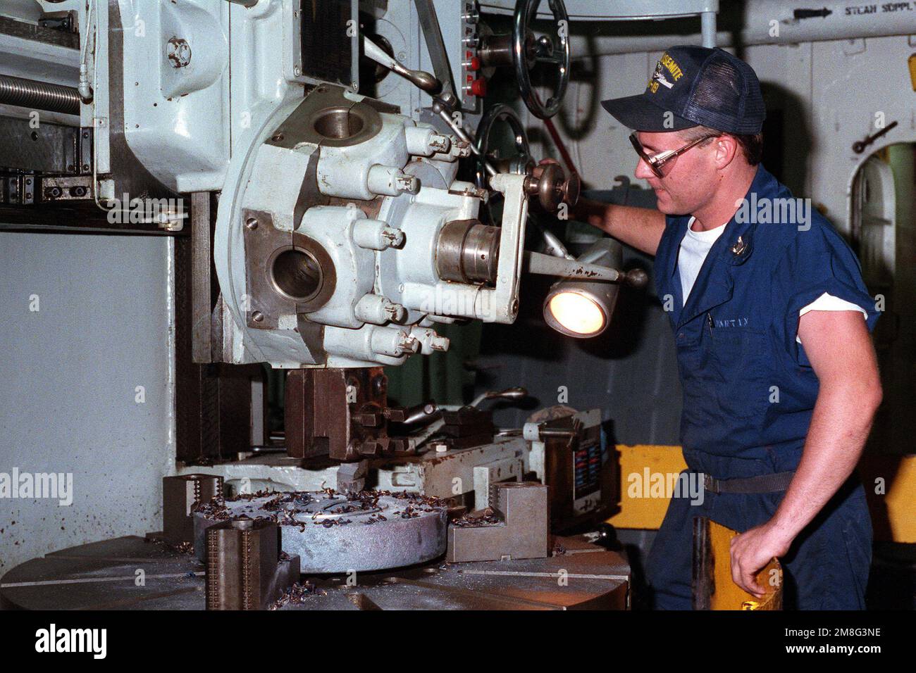 Machinery Repairman 3rd Class Brandon Martin uses a milling machine to ...