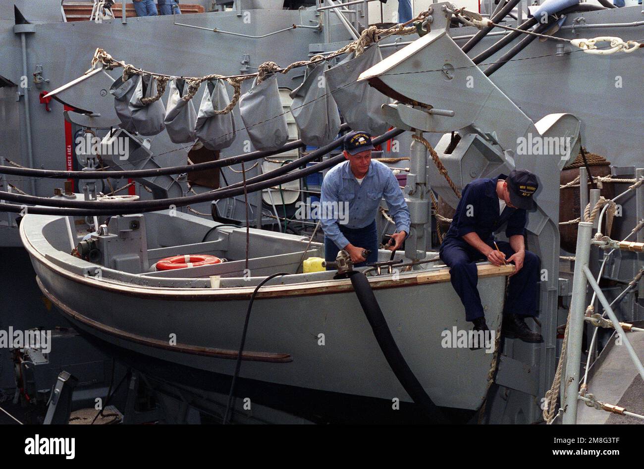 Hull Technician 3rd Class Nicholas Oswald, seated on bow, and SN Bryan ...