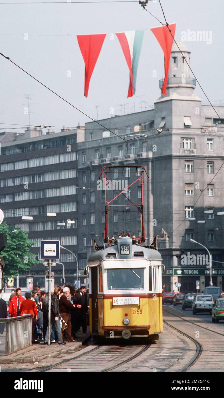 Passengers board a tram, the city's primary mode of transportation ...