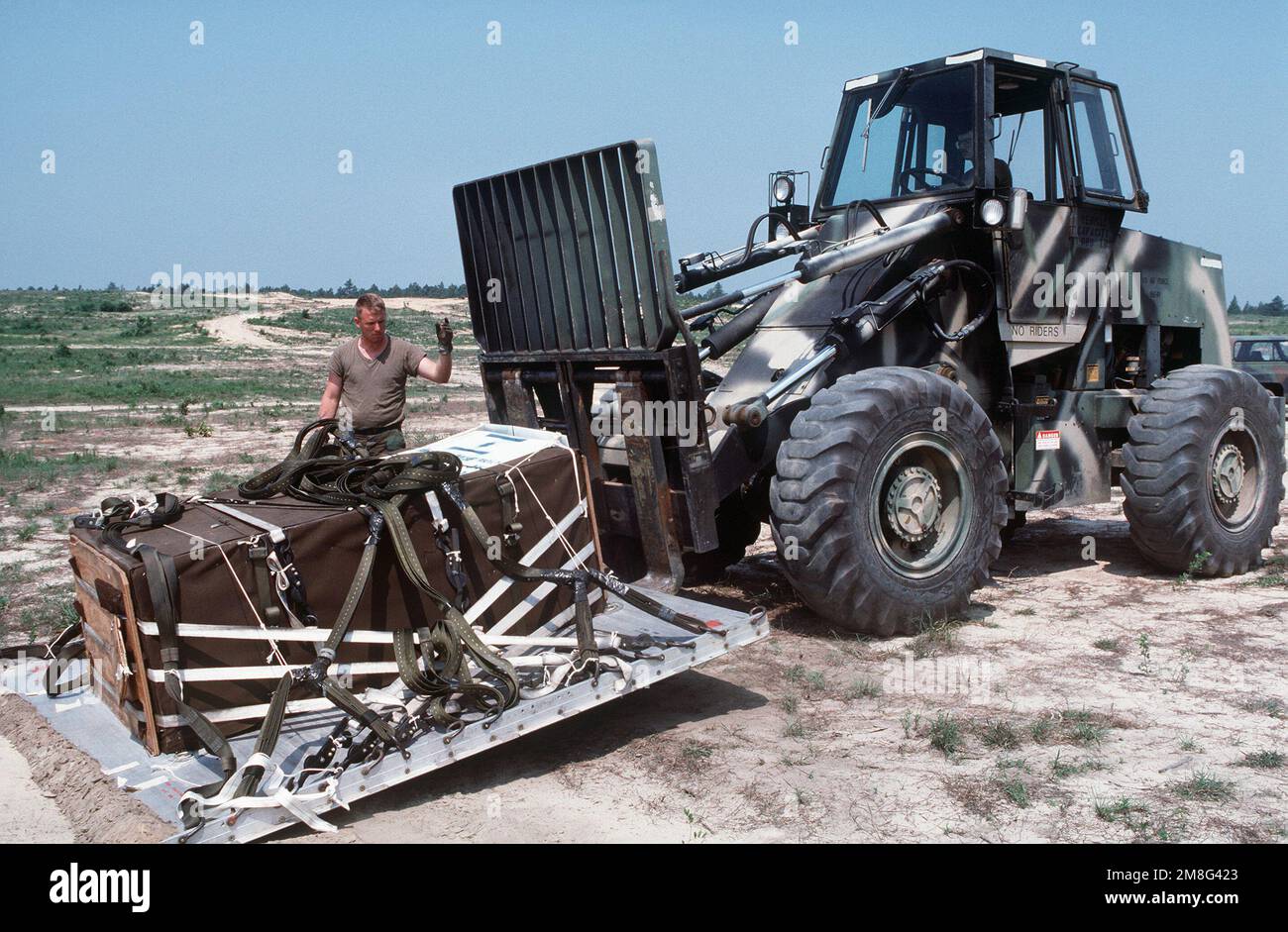 Parachute riggers from the 3rd Mobile Aerial Port Squadron use an M13K ...