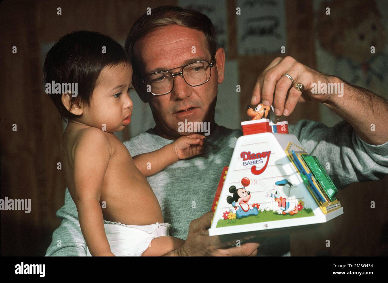 CMSGT Gerald Williams entertains a baby. Williams and other members of ...