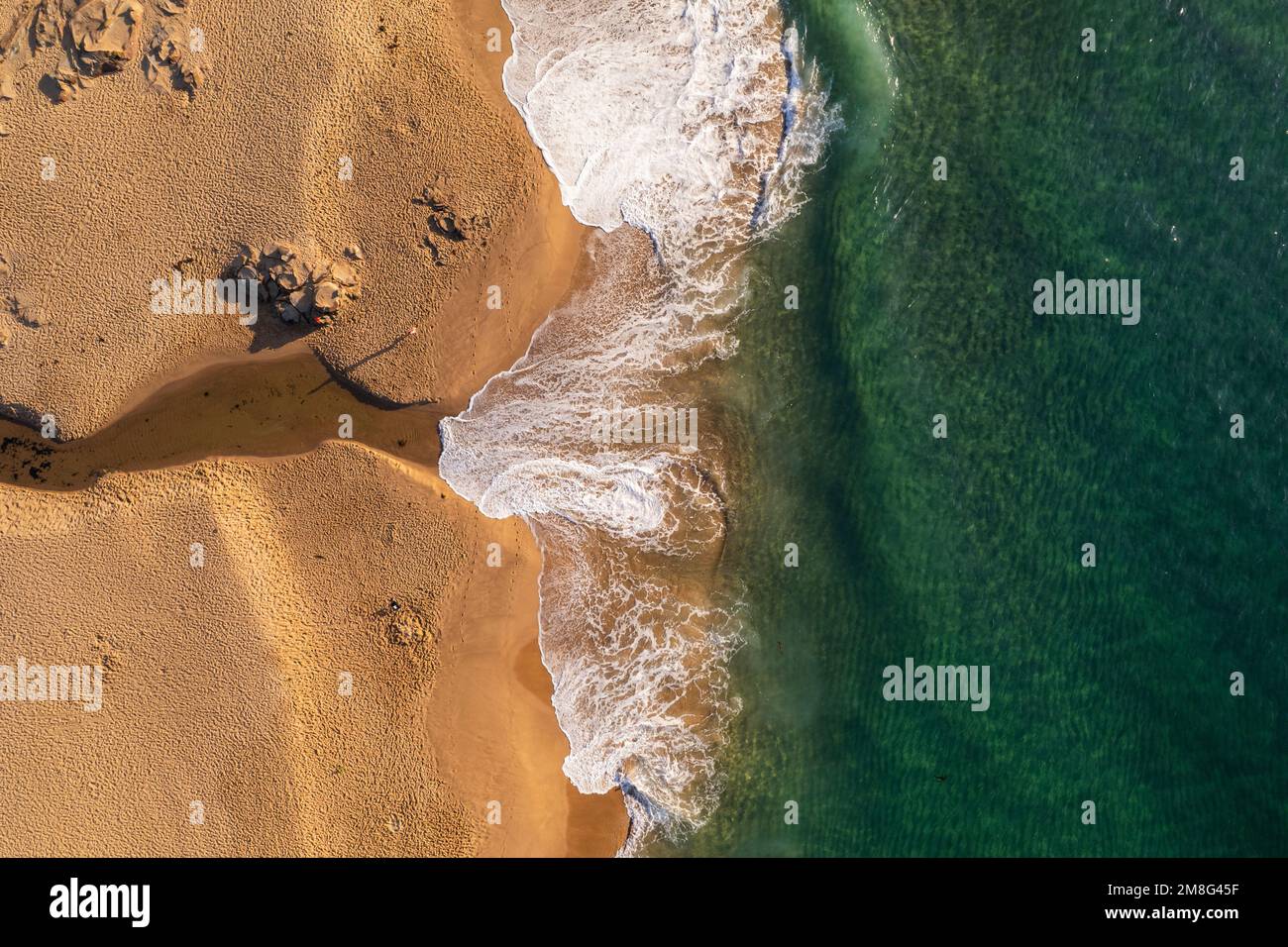 A Drone top shot over sea water and sandy beach Stock Photo - Alamy
