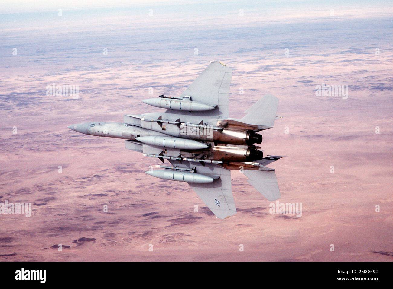A 58th Tactical Fighter Squadron F-15 Eagle aircraft banks to the right ...
