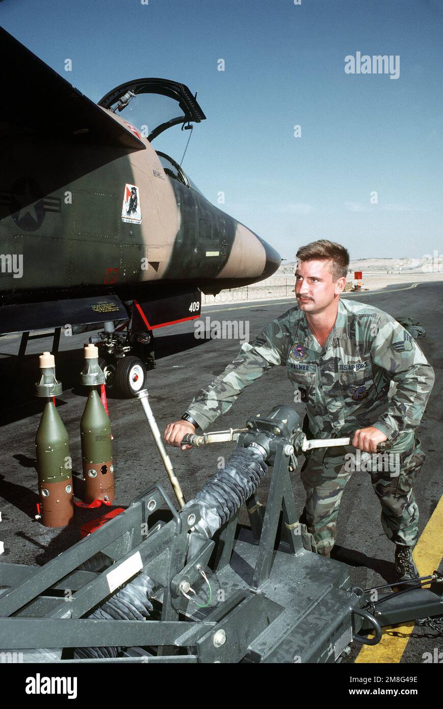 SENIOR AIRMAN Andrew Palmer uses a bomb loader to raise a 2,000-lb ...