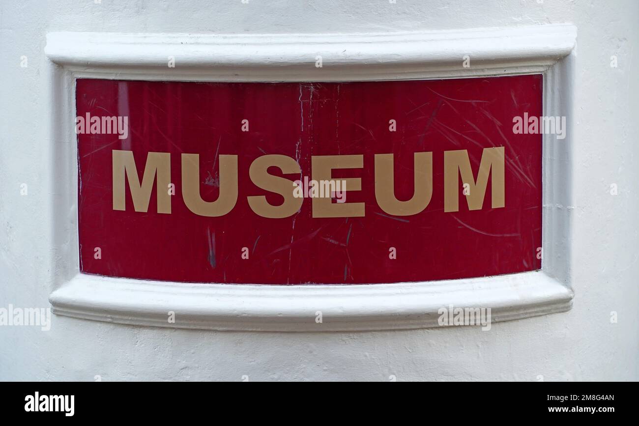 Museum written in golden letters on dark red background. Seen on the ...