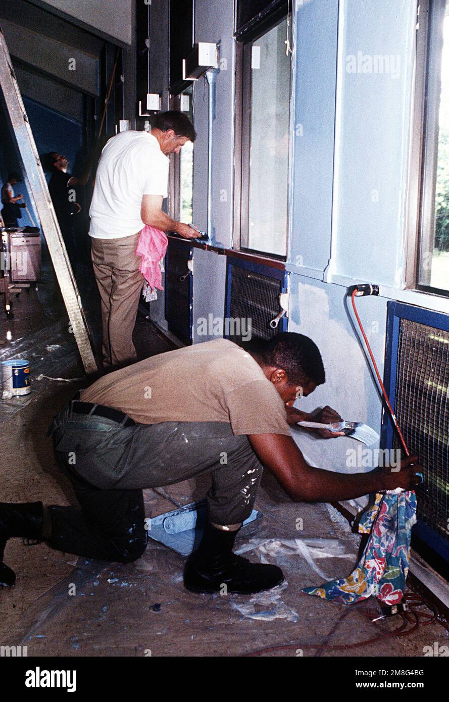 Sailors from the tank landing ship USS RACINE (LST-1191) paint the ...