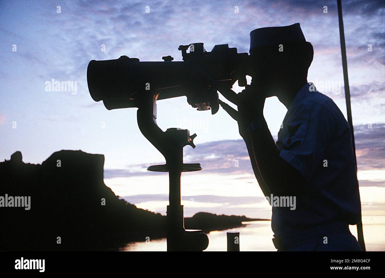 A sailor aboard the tank landing ship USS RACINE (LST 1191) studies his ...