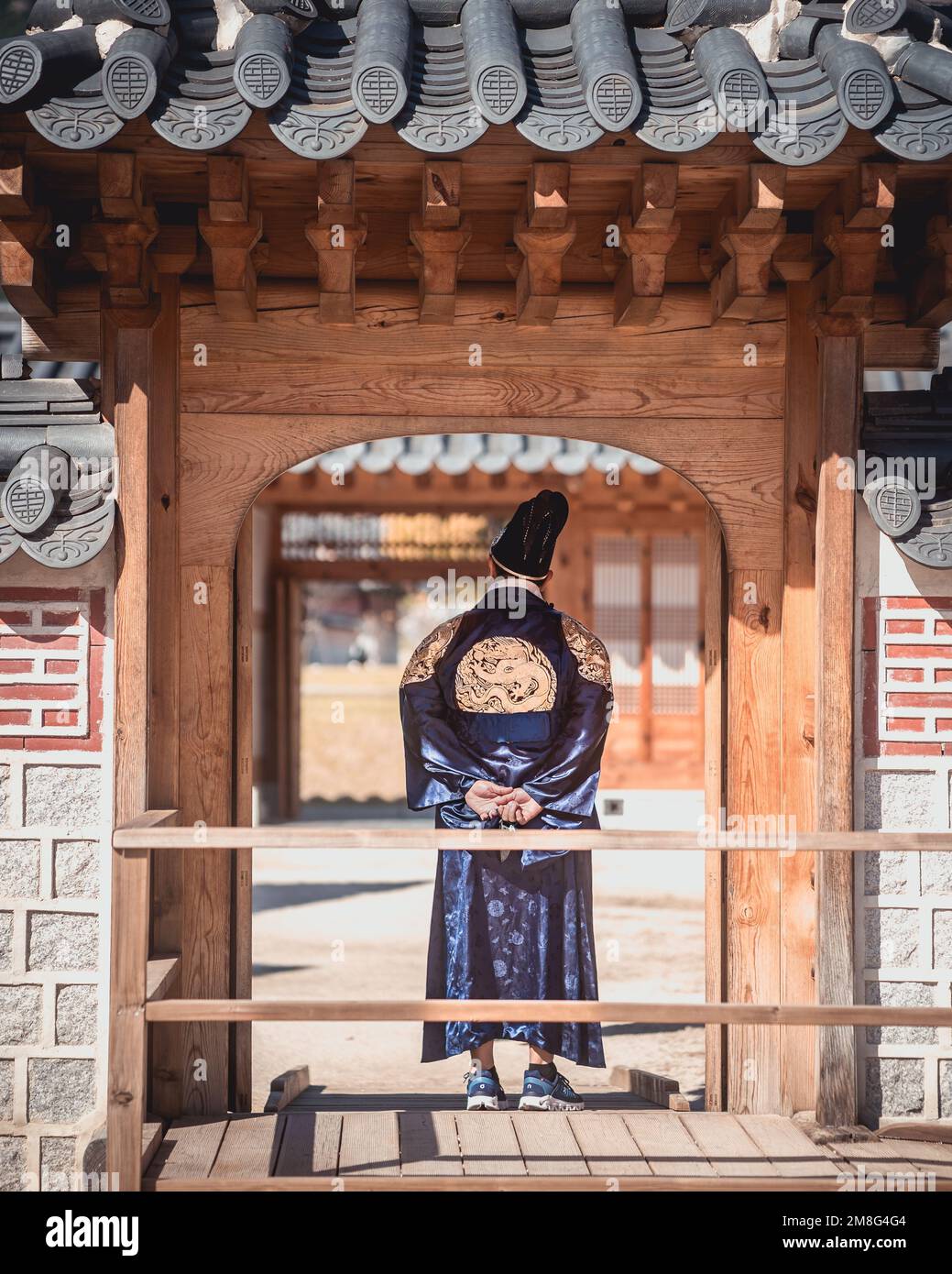 A vertical of a male dressed in the traditional hanbok Jeogori, walking ...