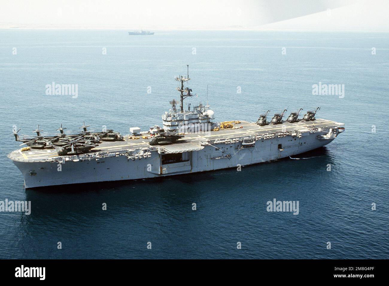 Various helicopters line the deck of the amphibious assault ship USS ...