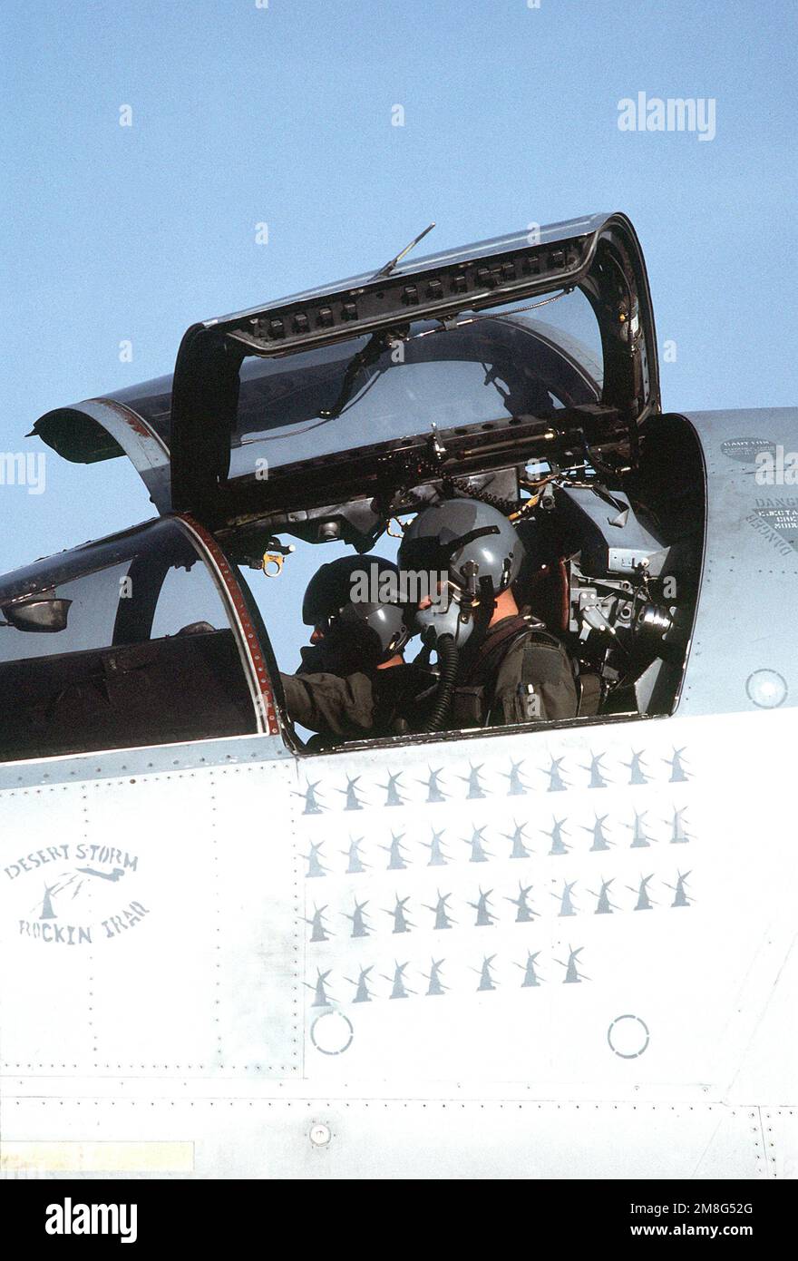 A pilot and copilot man the cockpit of an EF-111 Raven aircraft as they ...