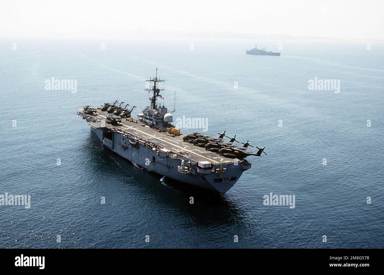 Various helicopters line the deck of the amphibious assault ship USS ...