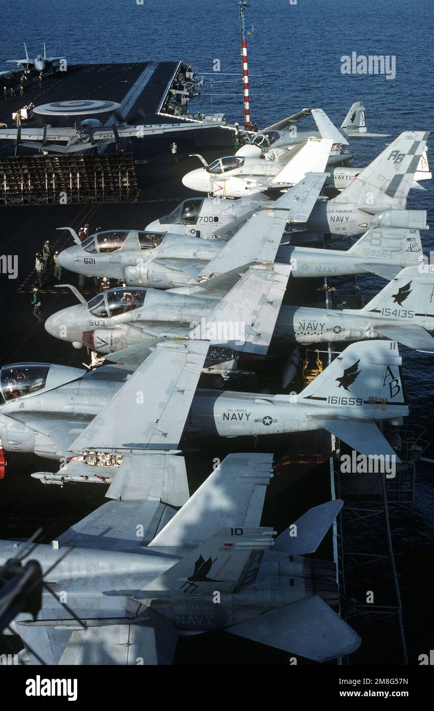 Various aircraft line the flight deck of the aircraft carrier USS ...