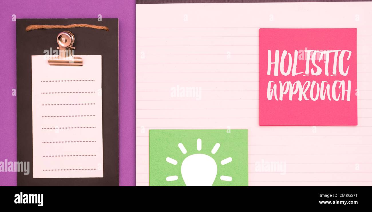 Hand writing sign Holistic Approach. Business overview characterized ...