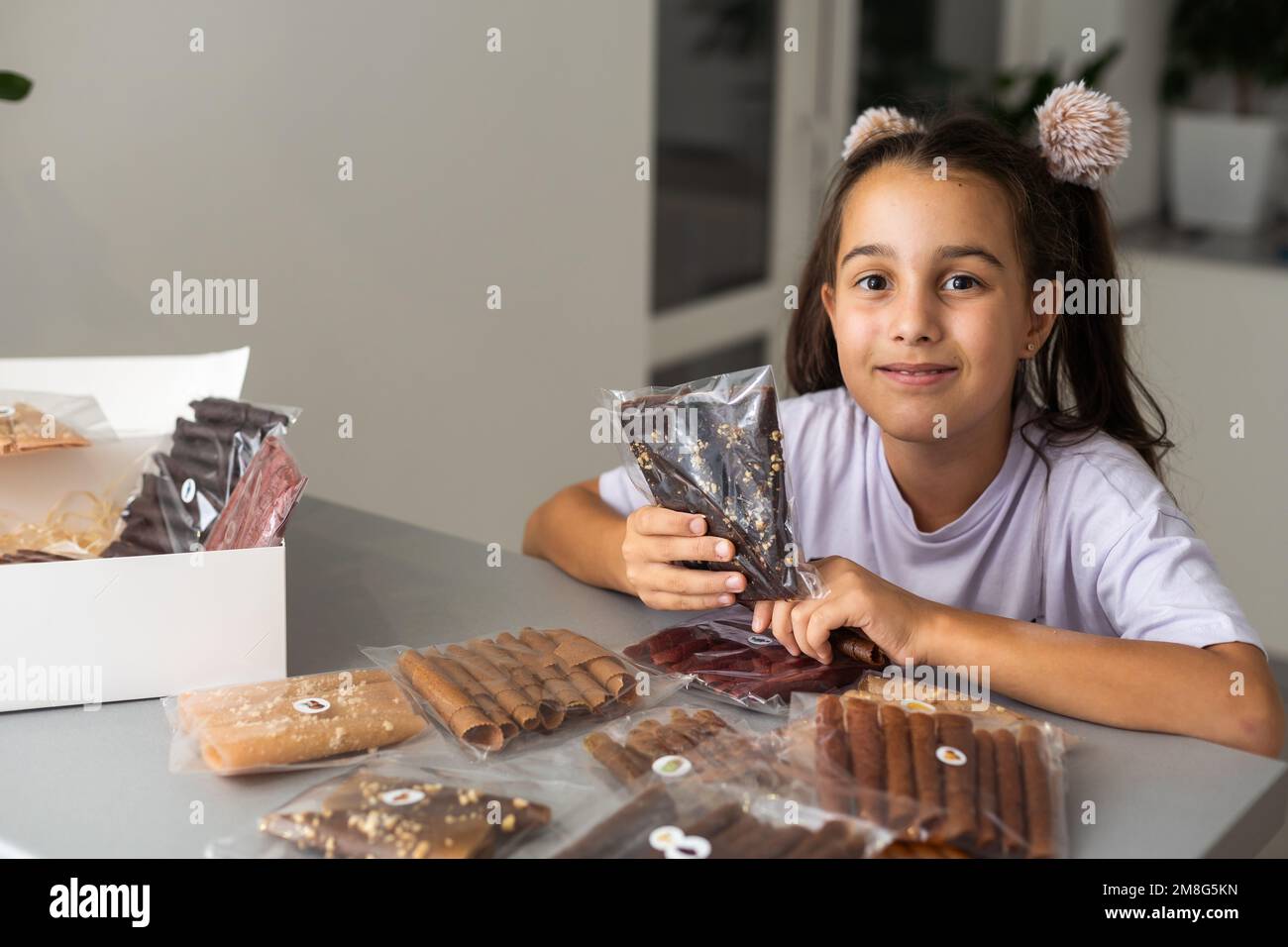 Little cute girl eating berry homemade paste candy Stock Photo - Alamy