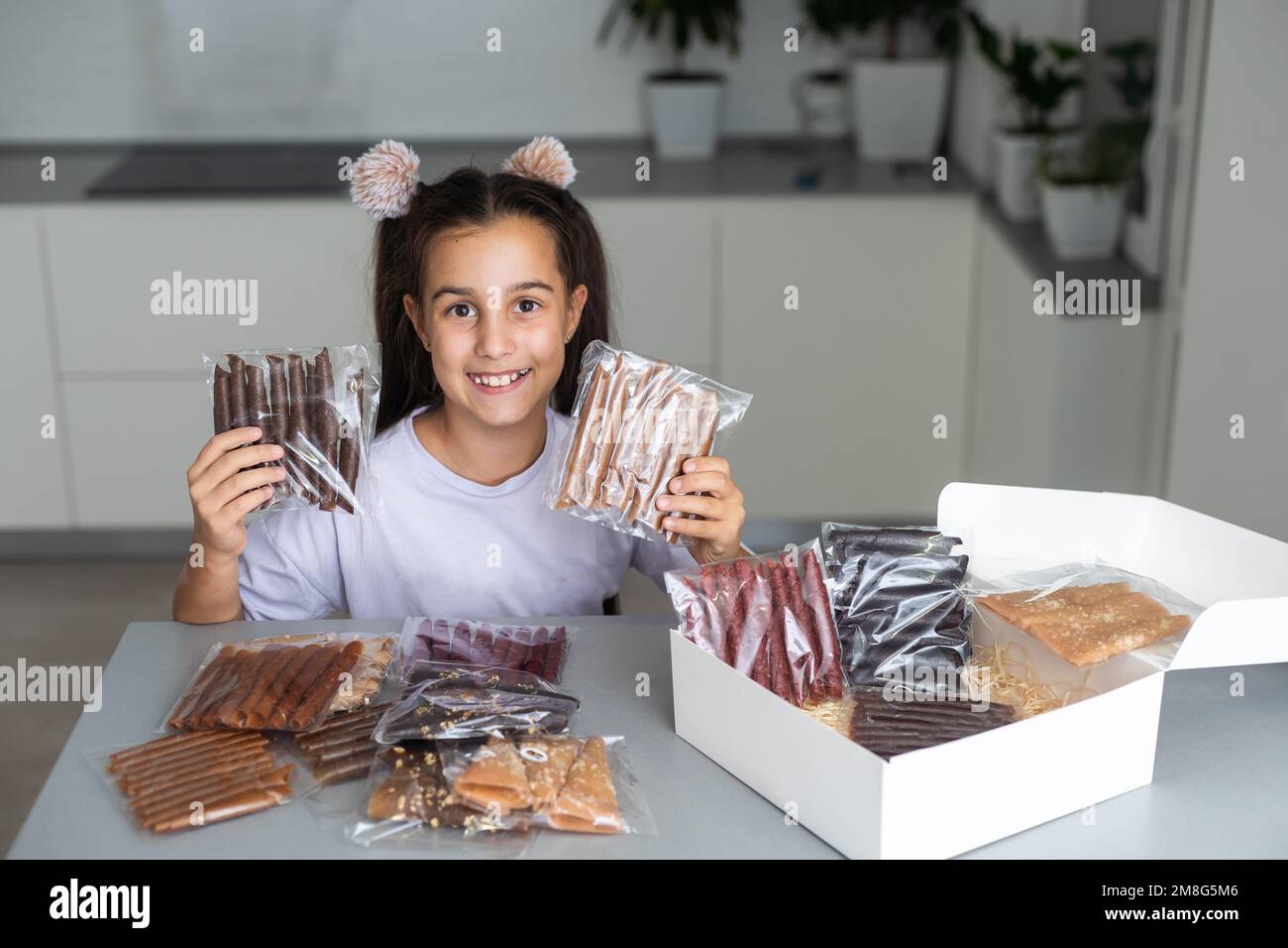 Little cute girl eating berry homemade paste candy Stock Photo - Alamy