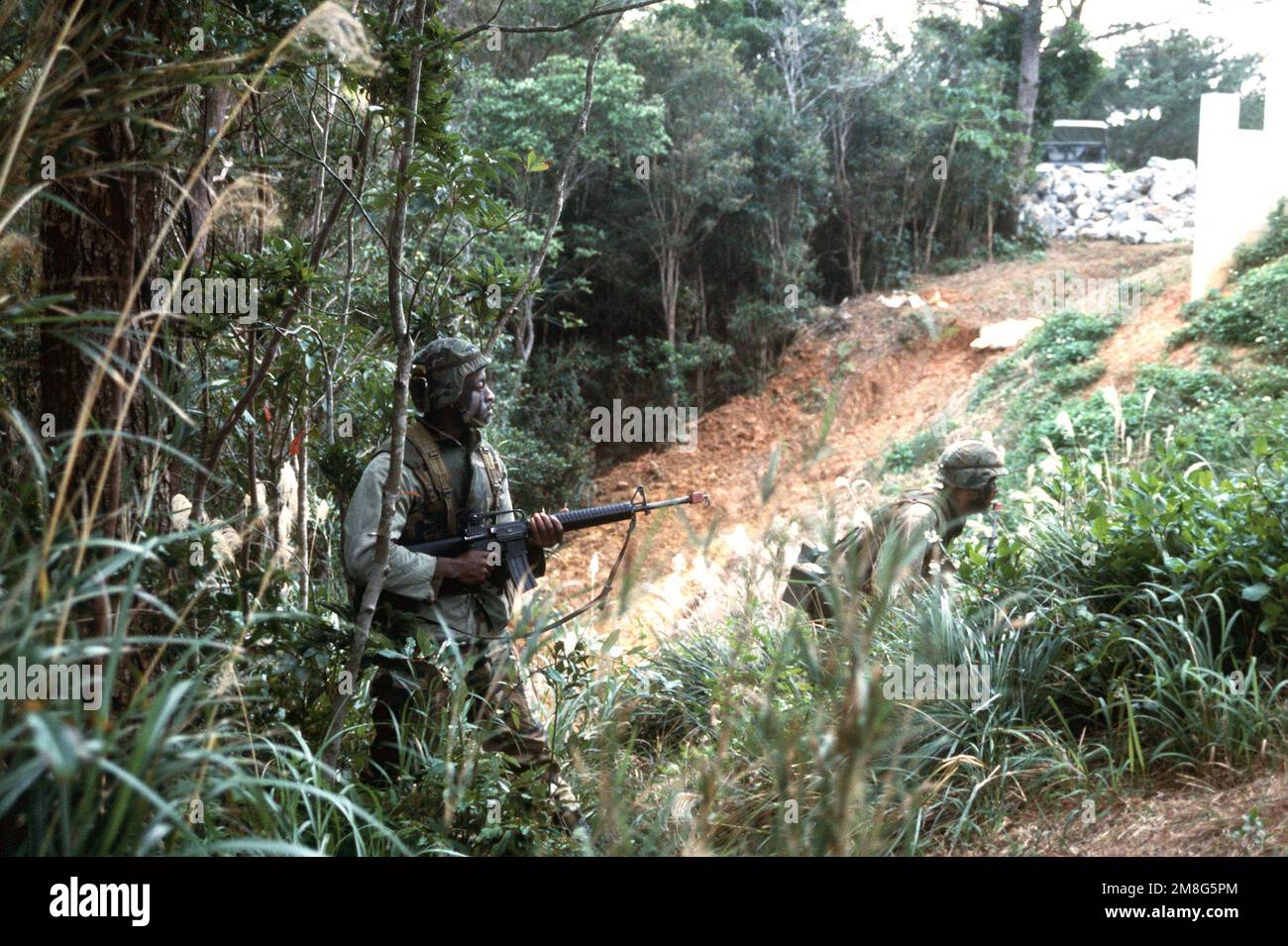 Two Marines approach the outskirts of combat town, a mock town built ...