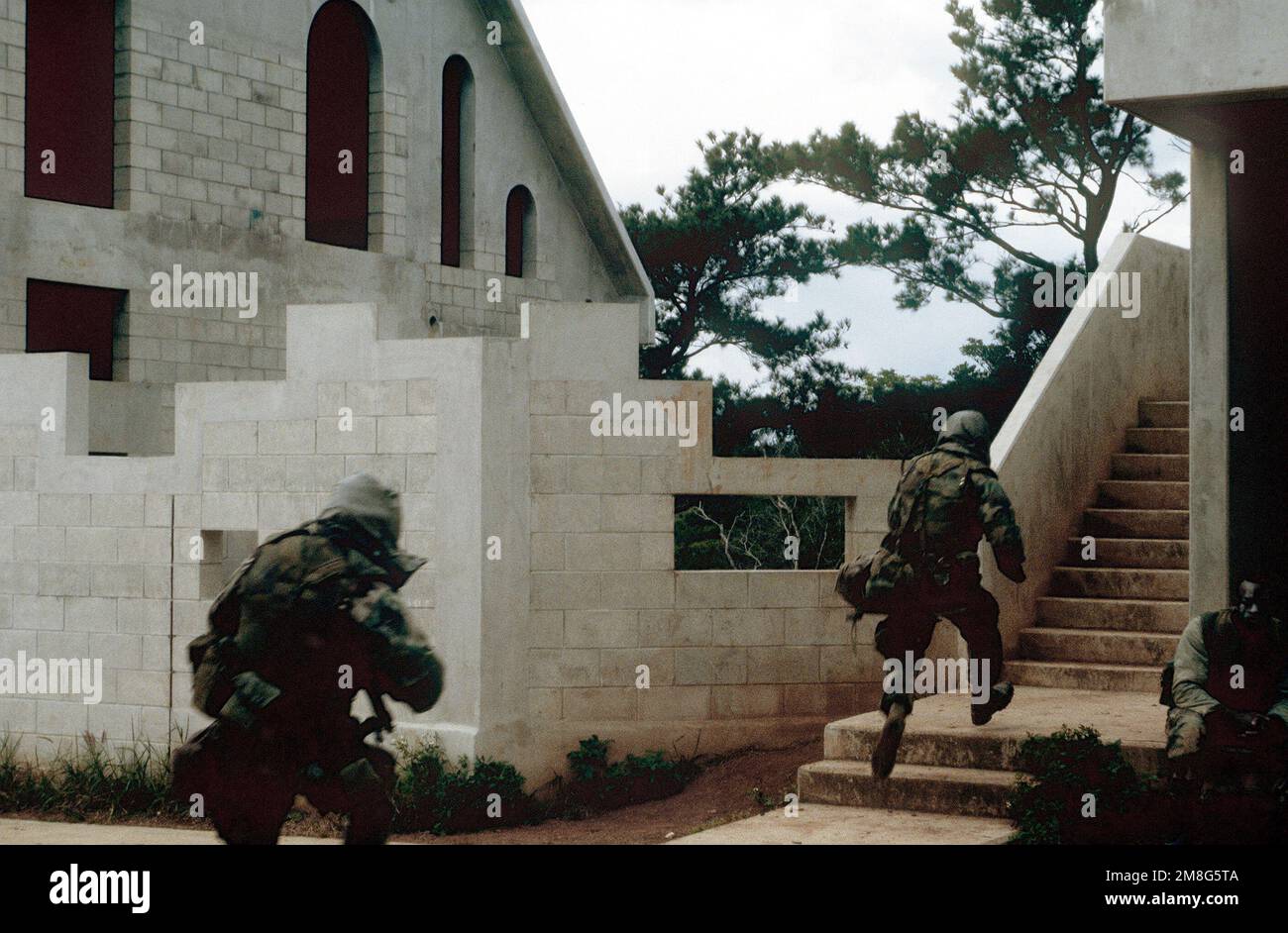 Two Marines rush a building in combat town, a mock town built for small ...