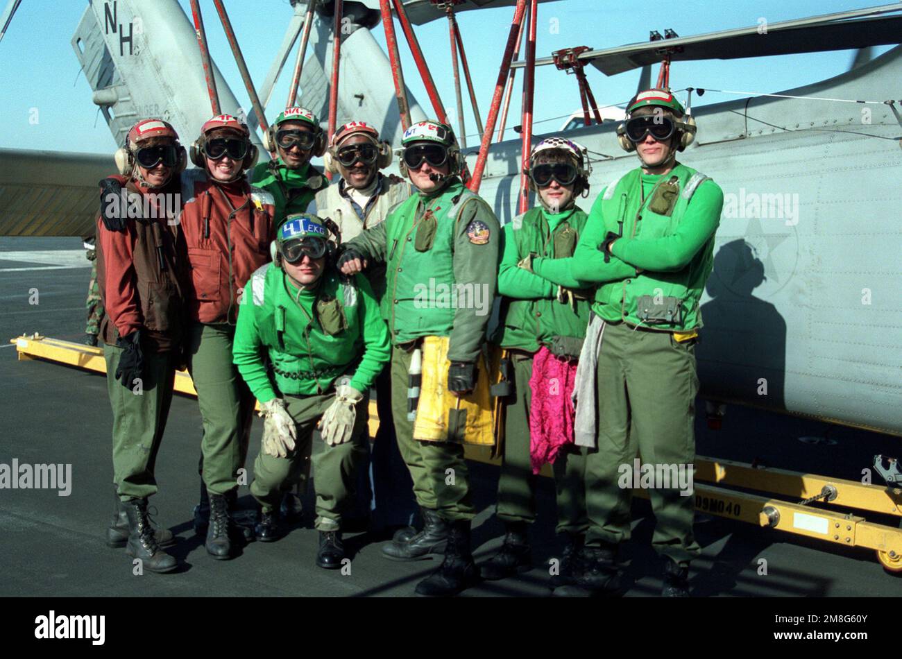 Flight deck crew members pose for a photograph on the nuclear-powered ...
