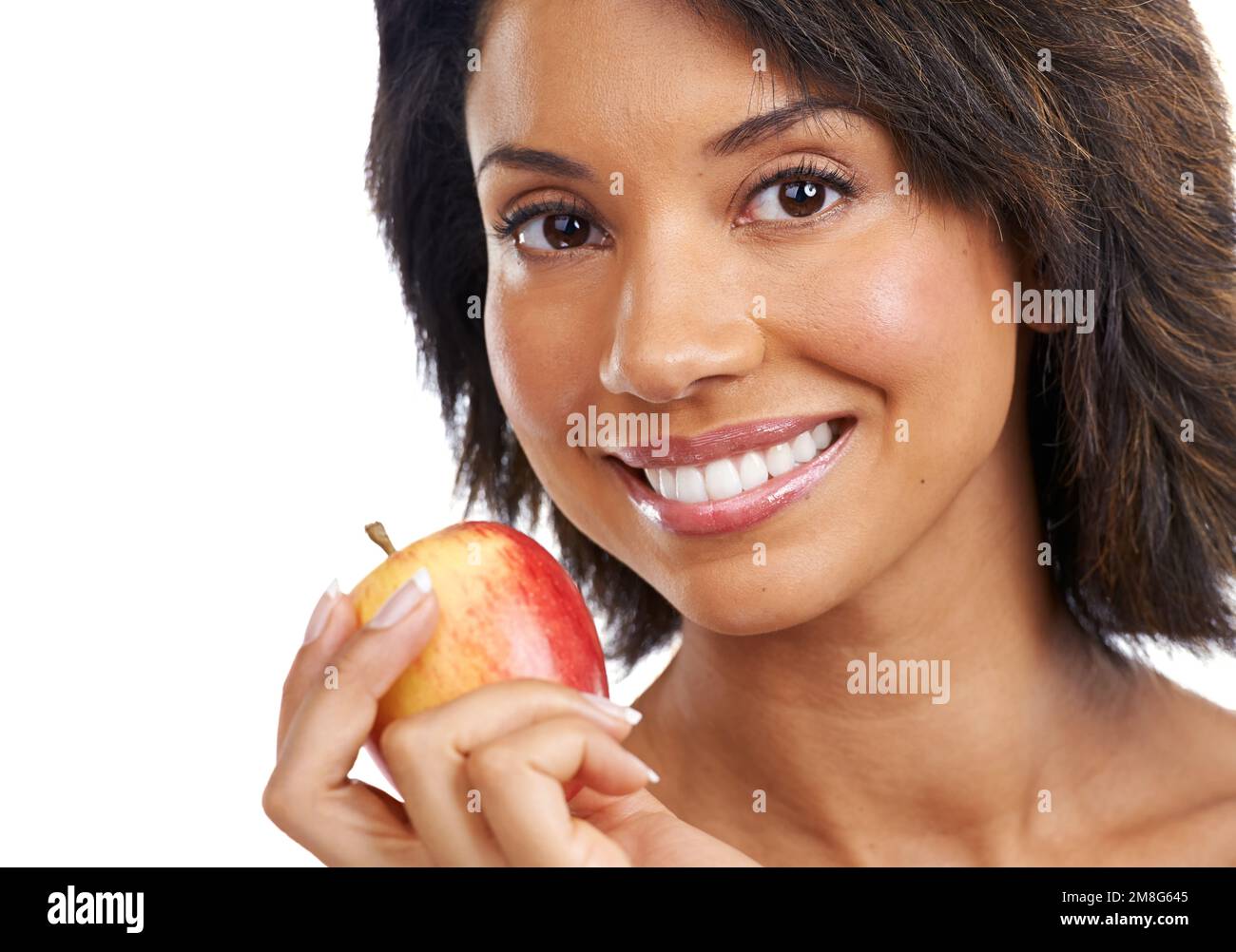 Portrait, fruit or happy black woman eating an apple in studio on white ...