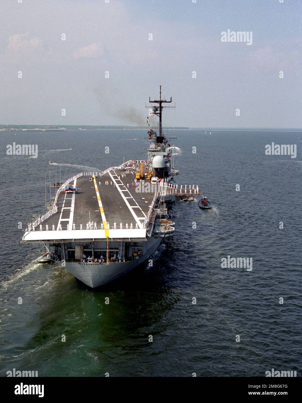 Crew members man the rails aboard the auxiliary aircraft landing ...