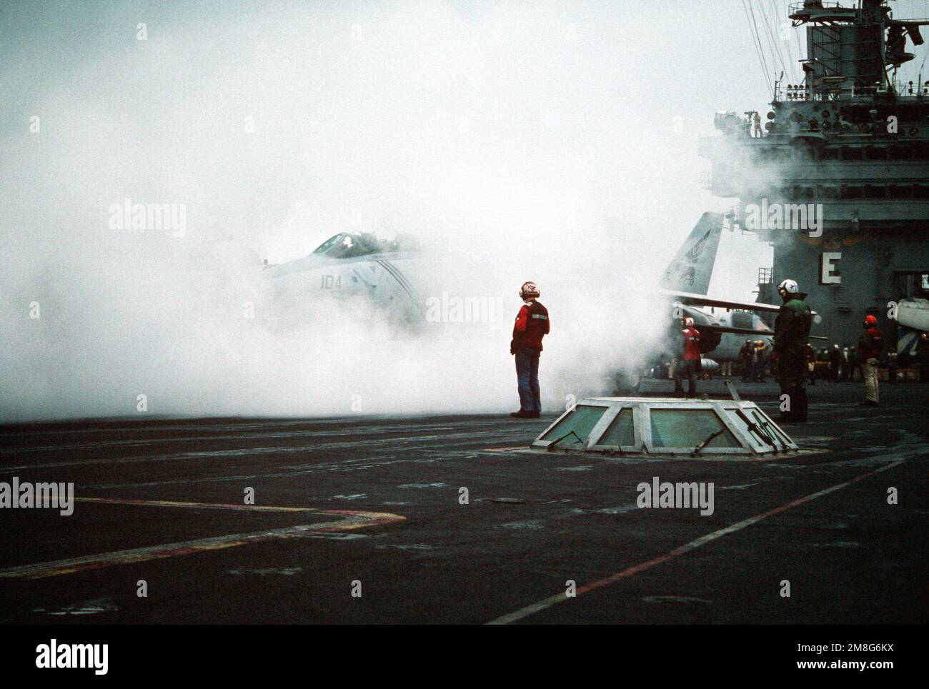 Steam from the catapult shrouds an F-14A Tomcat from Fighter Squadron ...