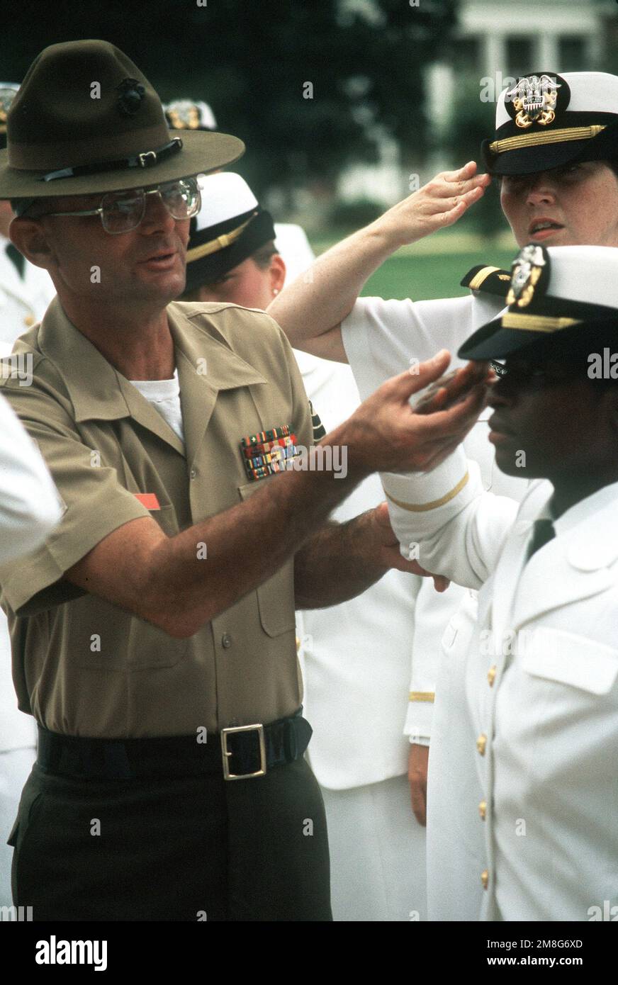 MASTER SGT. Charles Ryan, senior drill instructor, makes an adjustment ...