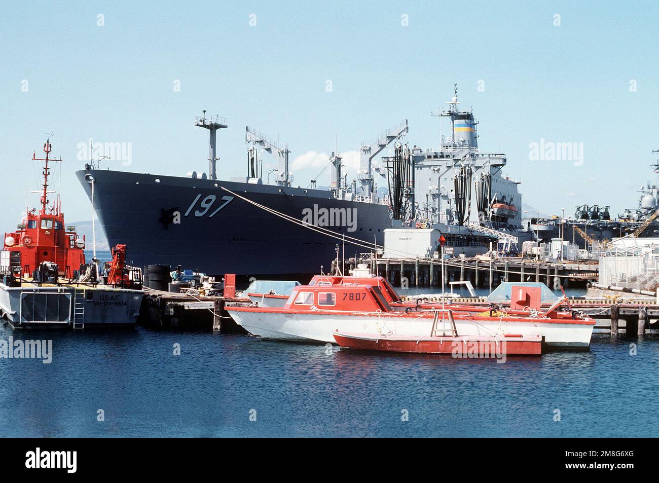 A port bow view of the oiler USNS PECOS (T-AO 197) tied to the pier ...