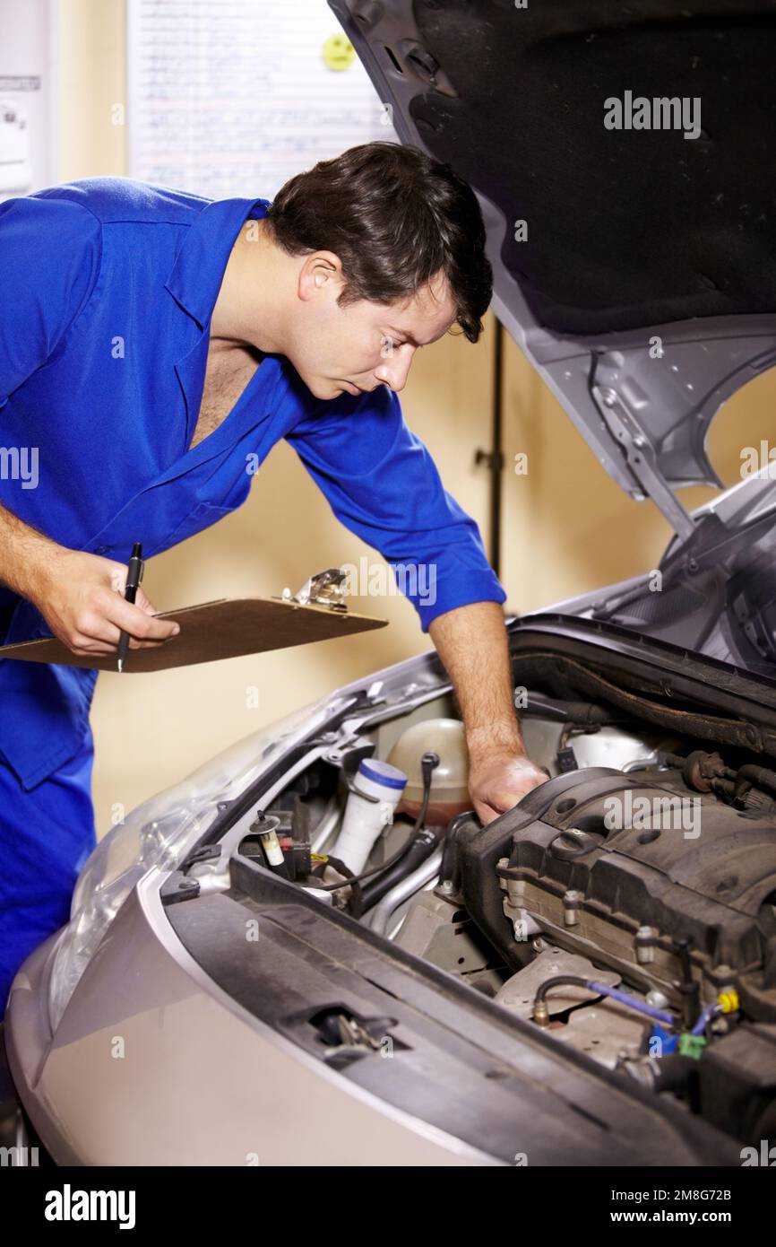 This seems to be the problem...A male mechanic holding a clipboard ...