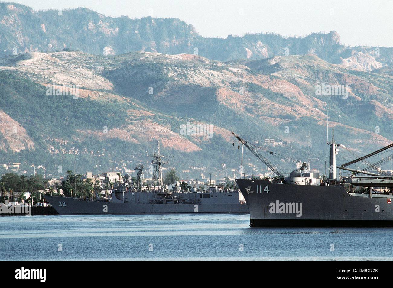 The amphibious cargo ship USS DURHAM (LKA-114), foreground, passes the ...